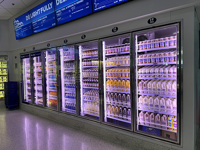 The refrigerated section glows like the pearly gates, a backlit paradise of dairy delights waiting to be chosen.