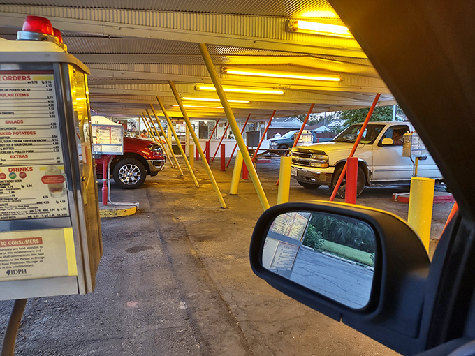 Drive-in dining from the driver's seat&mdash;where your car becomes the best table in the house. That menu board has witnessed more food decisions than a grocery store checkout line.