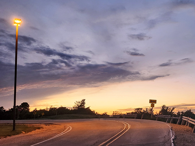 Twilight magic transforms ordinary country roads into pathways of possibility, the fading light painting promises of tomorrow's adventures.