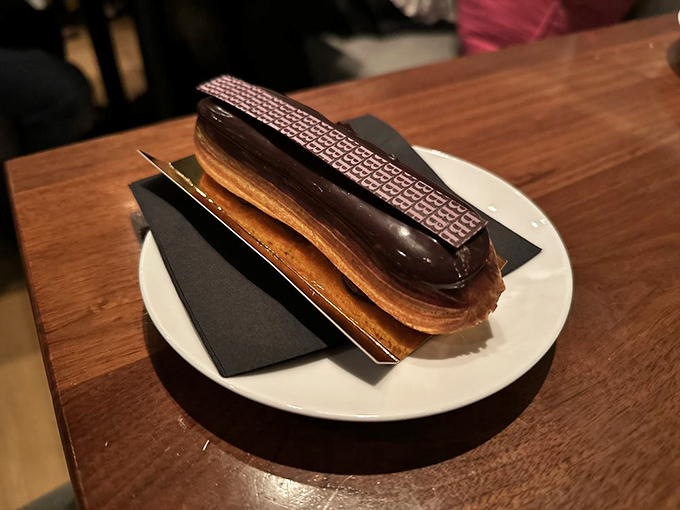 This &eacute;clair isn't just chocolate-topped pastry&mdash;it's a structurally perfect vessel delivering pure joy straight to your pleasure centers. Worth every calorie.