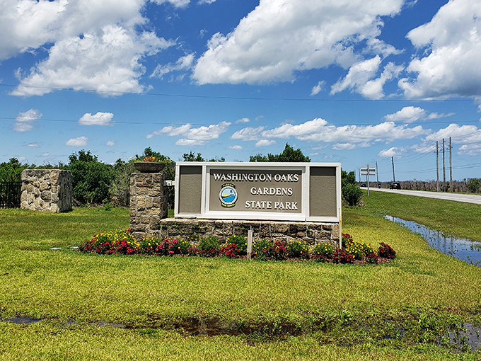 First impressions matter: The welcoming entrance sign promises the natural wonders that await beyond, framed by colorful Florida flora.