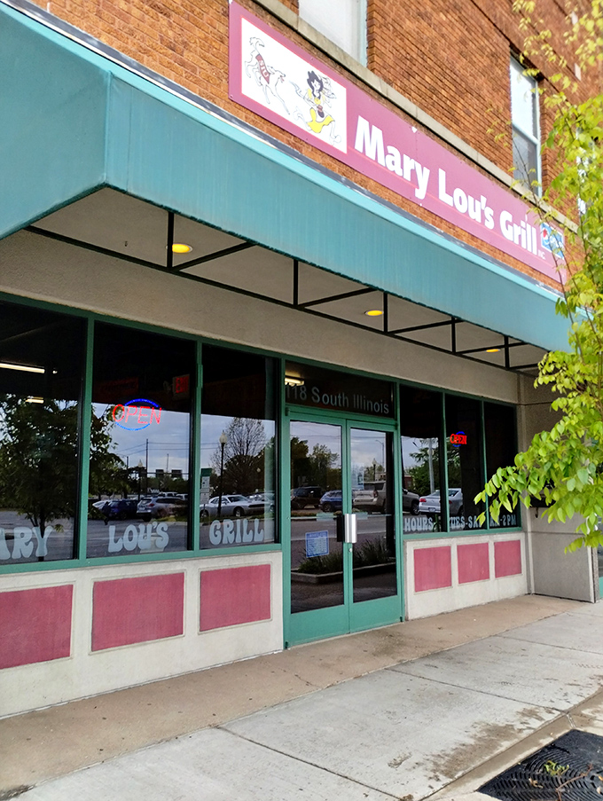 The storefront glows with welcoming simplicity, its green trim and pink accents promising honest food without pretension.