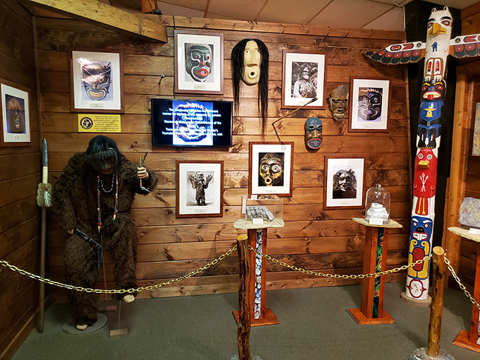 This exhibit blends indigenous masks with Bigfoot lore, creating a cultural tapestry where ancient traditions meet modern cryptozoology behind protective chains.