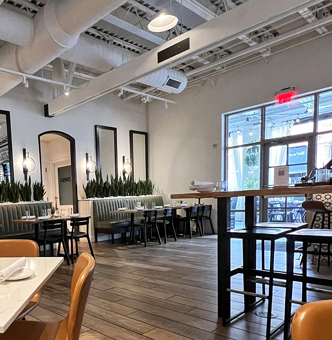 Clean lines and strategic plant placement make even casual dining feel refreshingly sophisticated and welcoming.