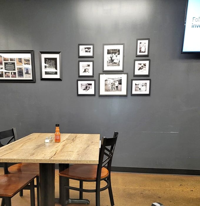 Black and white photographs tell stories on gray walls, offering glimpses of history between bites of comfort food.