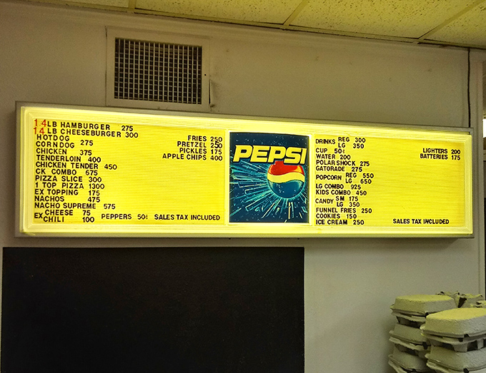 The illuminated menu board&mdash;a beacon of movie night sustenance. Decisions, decisions: nachos supreme or the classic cheeseburger combo?