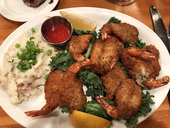 Fried shrimp so perfectly golden they deserve their own trophy, nestled beside mashed potatoes that clearly weren't made from a box.