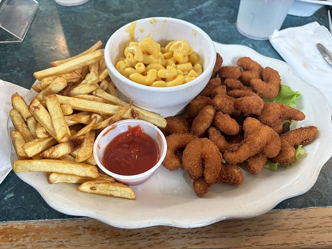 Golden-fried shrimp, crispy fries, and mac and cheese &ndash; the holy trinity of comfort food that makes you feel like a kid with a grown-up's appetite.