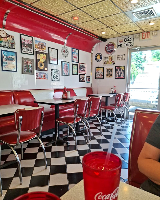 Red booths, Route 66 signs, and that "Kiss My Grits" wall art&mdash;this isn't decoration, it's a love letter to American diner culture.
