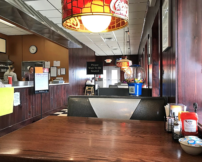 Stained glass pendant lights cast a warm glow over wooden tables, creating the perfect backdrop for memorable family meals.