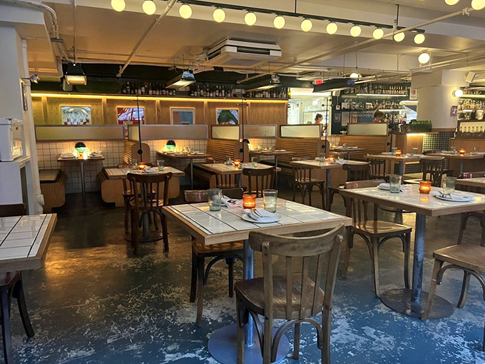 Evening transforms the space into a cozy dining room where globe lights cast a flattering glow on both the food and your dinner date.