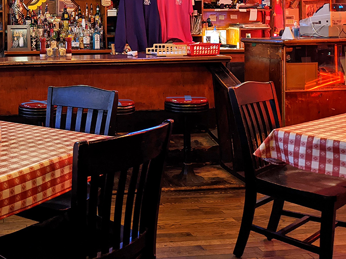 Red-checkered tablecloths and wooden chairs create the kind of dining room where conversations flow as freely as the coffee refills.