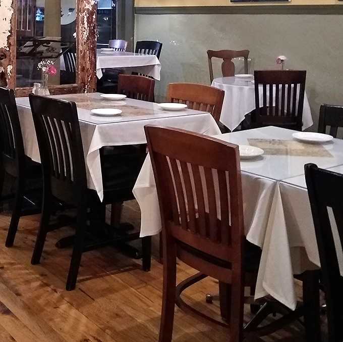 Wooden chairs, white tablecloths, and walls the color of Tuscan sunshine—simplicity that lets the food be the real conversation starter.