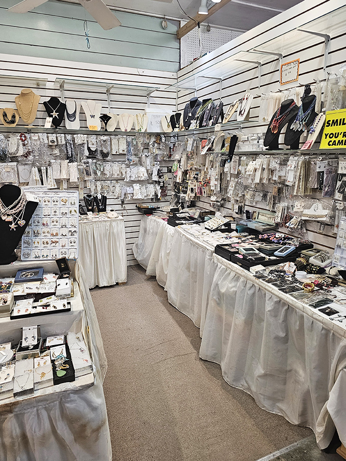 Jewelry displays that transform shopping into a treasure hunt. White tablecloths and bright lights make even modest pieces feel like crown jewels.