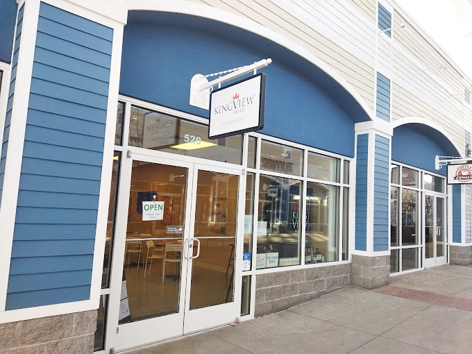 Kingview's sleek blue storefront offers a moment of calm amid the shopping frenzy, like finding an oasis in a desert of discounts.