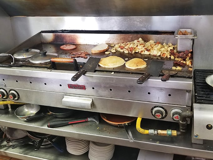 The griddle ballet in action &ndash; where pancakes, potatoes, and perfection dance together in cast-iron choreography.