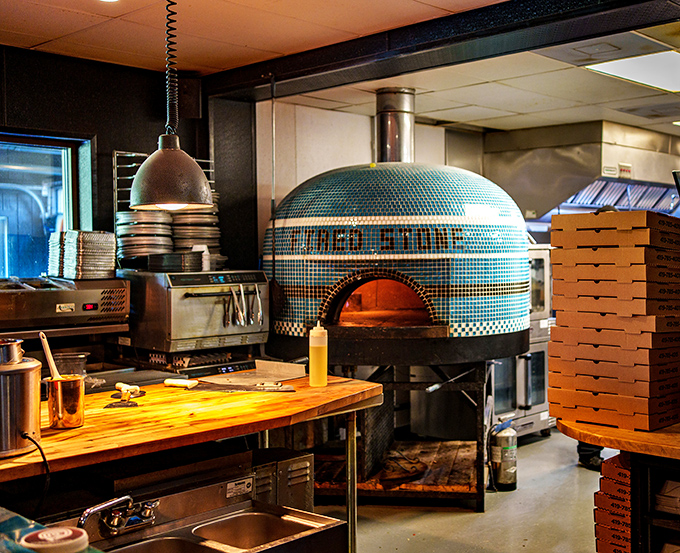 The tiled pizza oven isn't just equipment &ndash; it's the beating heart of the kitchen, where smoke and fire transform ingredients into memories.