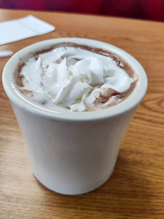 Hot chocolate topped with whipped cream&mdash;comfort in a mug that whispers, "Everything's going to be okay" with every sip.