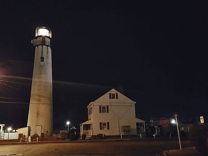Even at night, the lighthouse keeps its vigil, a glowing reminder of maritime history that refuses to be forgotten.