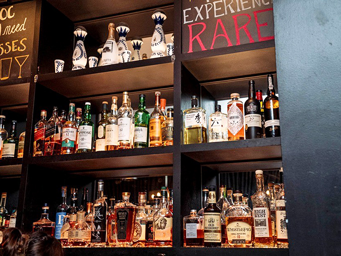 Behind those bottles is liquid happiness waiting to happen. The "Experience Rare" sign isn't just decoration&mdash;it's a promise.