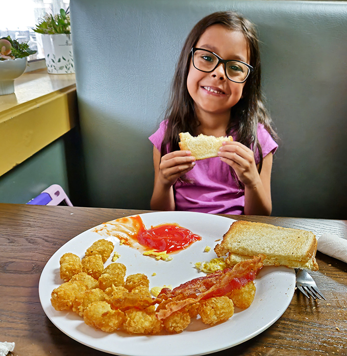 The next generation of Westside fans discovering the simple joy of perfectly cooked bacon and golden tater tots.