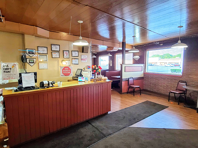 The front counter welcomes you like an old friend, with its warm wood paneling and no-nonsense efficiency. Chicken paradise lies just beyond.
