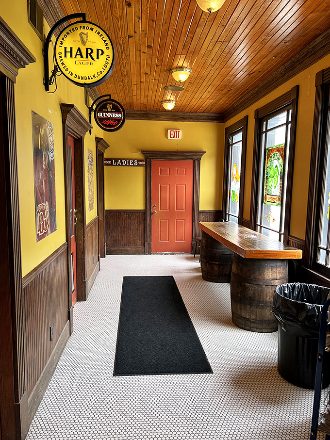 The entryway feels like a portal to another era. Those barrel tables aren't just furniture; they're conversation starters with a history of their own.