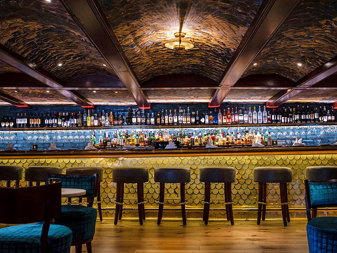 The bar's ceiling tells stories of ocean voyages while mixologists below craft liquid tales worth savoring one sip at a time.