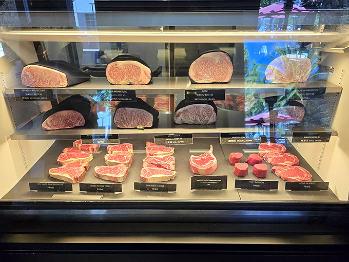 Raw beef display case revealing nature's finest marbling patterns - each cut tells its own delicious story of terroir and tradition.