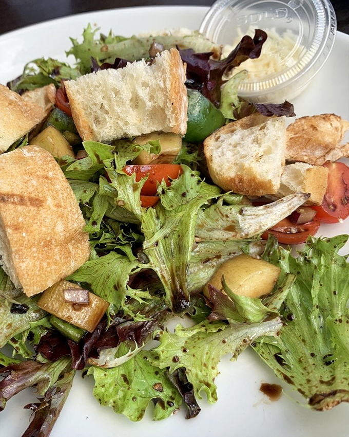 Even the salad deserves attention &ndash; fresh greens, tomatoes, and those perfect cubes of cheese that make vegetables suddenly very interesting.