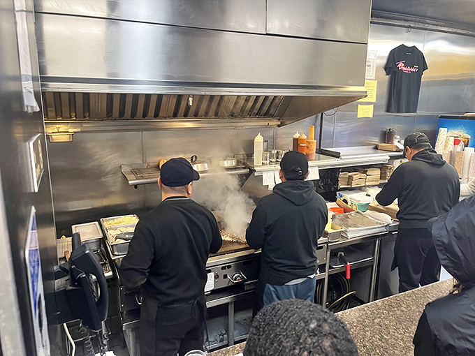 Kitchen choreography at its finest&mdash;the grill masters working their magic in a steam-filled dance of spatulas and sizzle.