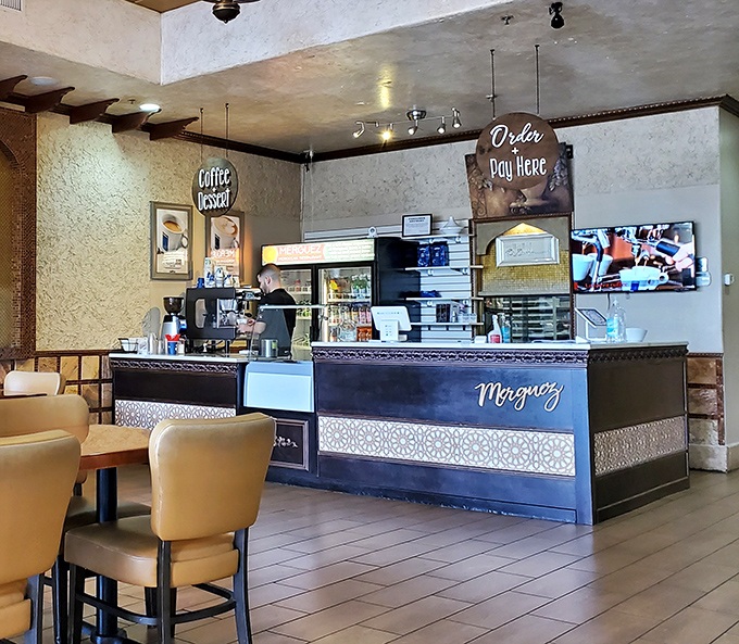 The counter where culinary dreams come true, adorned with Moroccan-inspired details and a sign that helpfully reminds you where to pay.