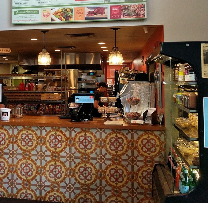 Behind this counter, pizza artisans transform simple ingredients into edible masterpieces that keep locals coming back weekly.