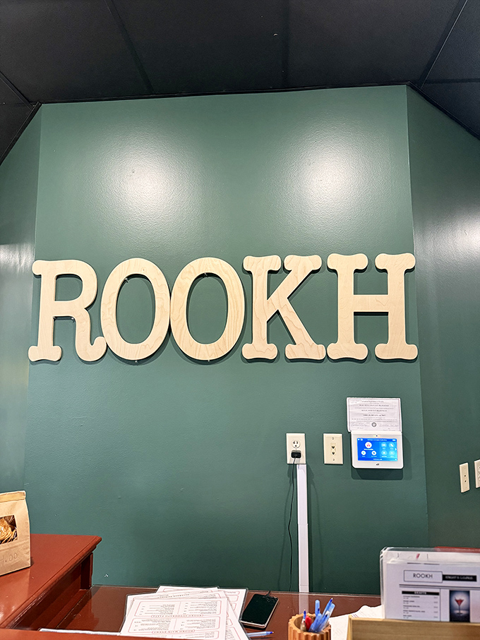 The wooden ROOKH sign against that soothing green wall says it all. Simple, bold, and memorable&mdash;just like the flavors waiting to be discovered.