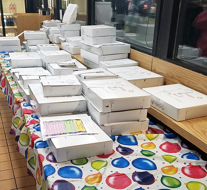 White boxes stacked like a Jenga tower of joy, each one containing someone's moment of happiness, carefully labeled and ready for pickup.