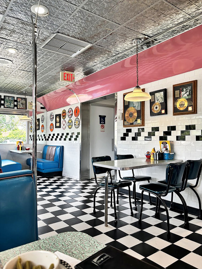The pressed tin ceiling and vintage gold records aren't decoration&mdash;they're time capsules. Each booth has probably witnessed first dates that led to marriages.