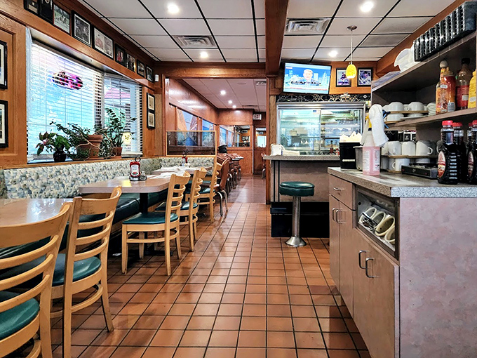 Counter seating where regulars perch like birds on a wire, watching the breakfast ballet unfold in the kitchen beyond.