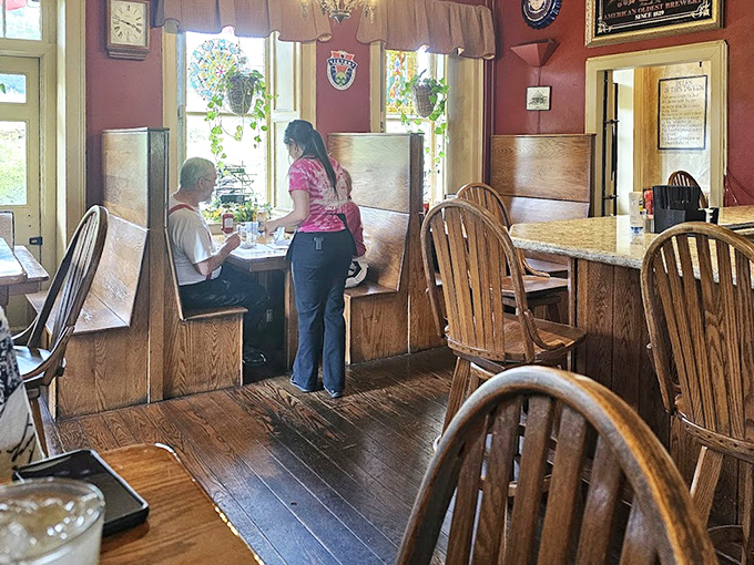 Wooden booths worn smooth by generations of diners create intimate dining islands where conversations flow as freely as the coffee refills.