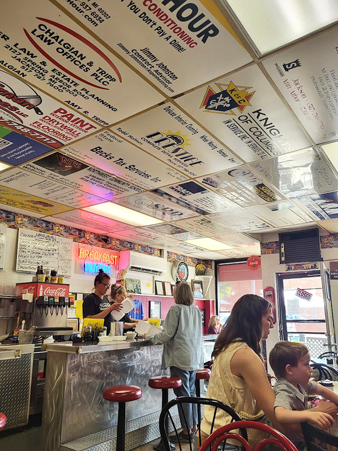 Counter seating where strangers become friends over coffee refills and shared appreciation for real American diner culture.
