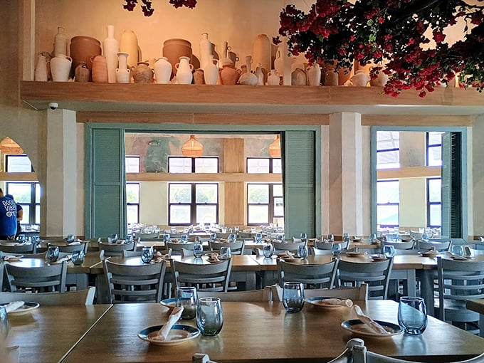 The dining room balances rustic charm with elegant simplicity, where terracotta pots and Mediterranean blue accents create the perfect backdrop for the coming food drama.