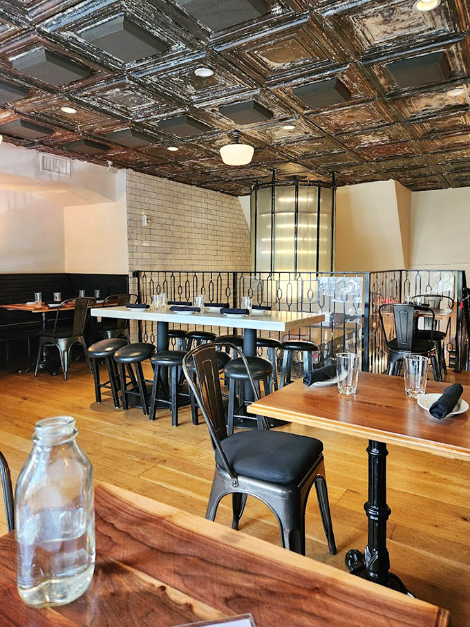 The vintage ceiling tiles watch over diners like guardians of good taste, while natural light pours in through those factory-style windows.
