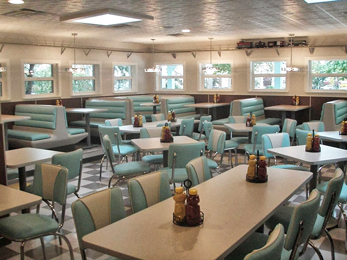 The mint-green booths and classic diner tables create an atmosphere where conversations flow as easily as the coffee refills.