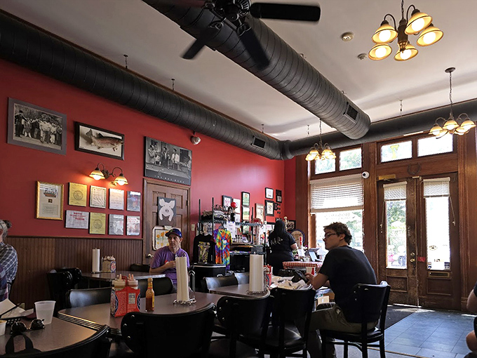 Red walls adorned with accolades and memorabilia create the perfect backdrop for the serious business of BBQ appreciation.