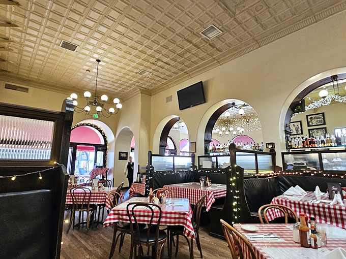 Arched doorways frame the dining room like a stage where breakfast dreams come true. The tin ceiling adds a touch of vintage glamour.