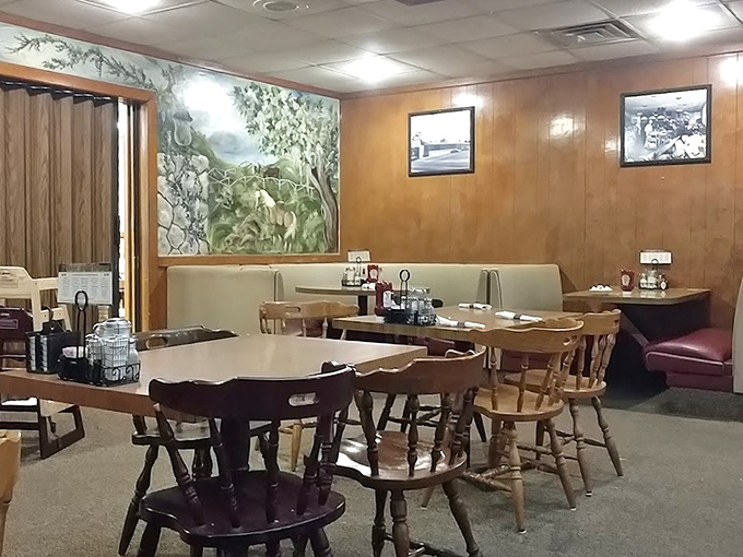 Another dining room corner reveals a pastoral mural&mdash;because nothing complements pancakes quite like a peaceful countryside scene painted decades ago.
