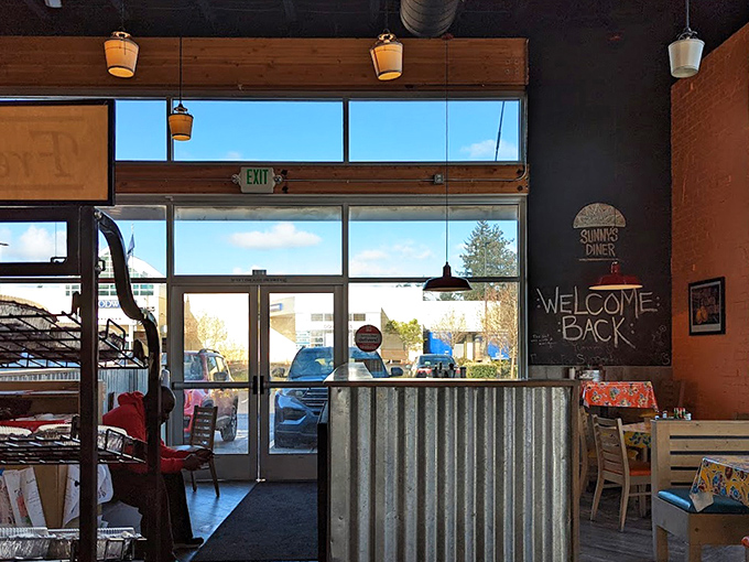 Natural light floods through windows that frame Happy Valley like a postcard, while "Welcome Back" on the chalkboard feels genuinely meant.
