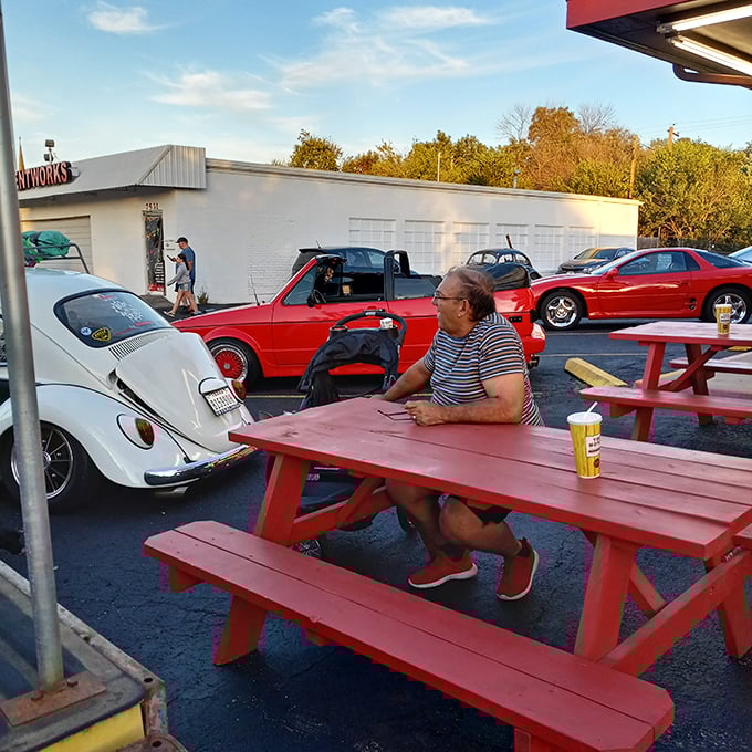 Outdoor picnic tables where vintage car enthusiasts gather, proving that good taste extends beyond just the food at this Austin landmark.