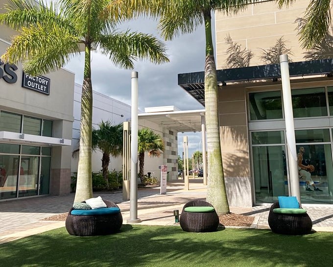 Outdoor lounging spots with artificial grass where exhausted husbands wait for their shopping warriors.