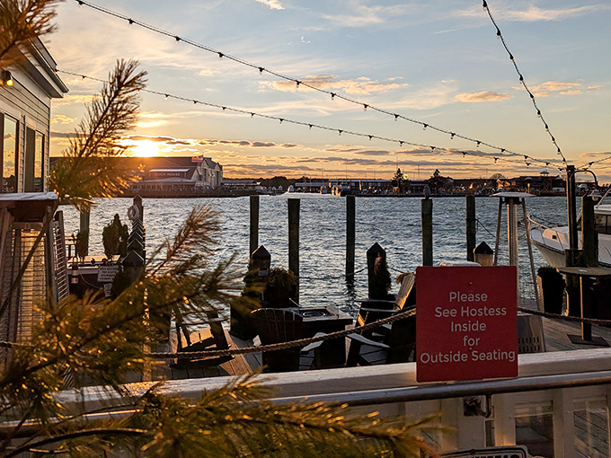 Sunset over the water with string lights overhead&mdash;Mother Nature's dinner theater. The perfect backdrop for seafood memories in the making.