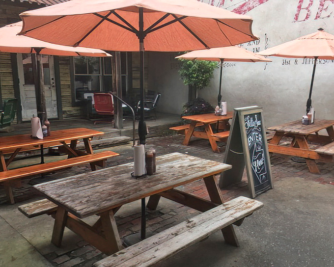 The outdoor courtyard feels like the best backyard party you've ever crashed, complete with picnic tables and the promise of meat-induced euphoria.